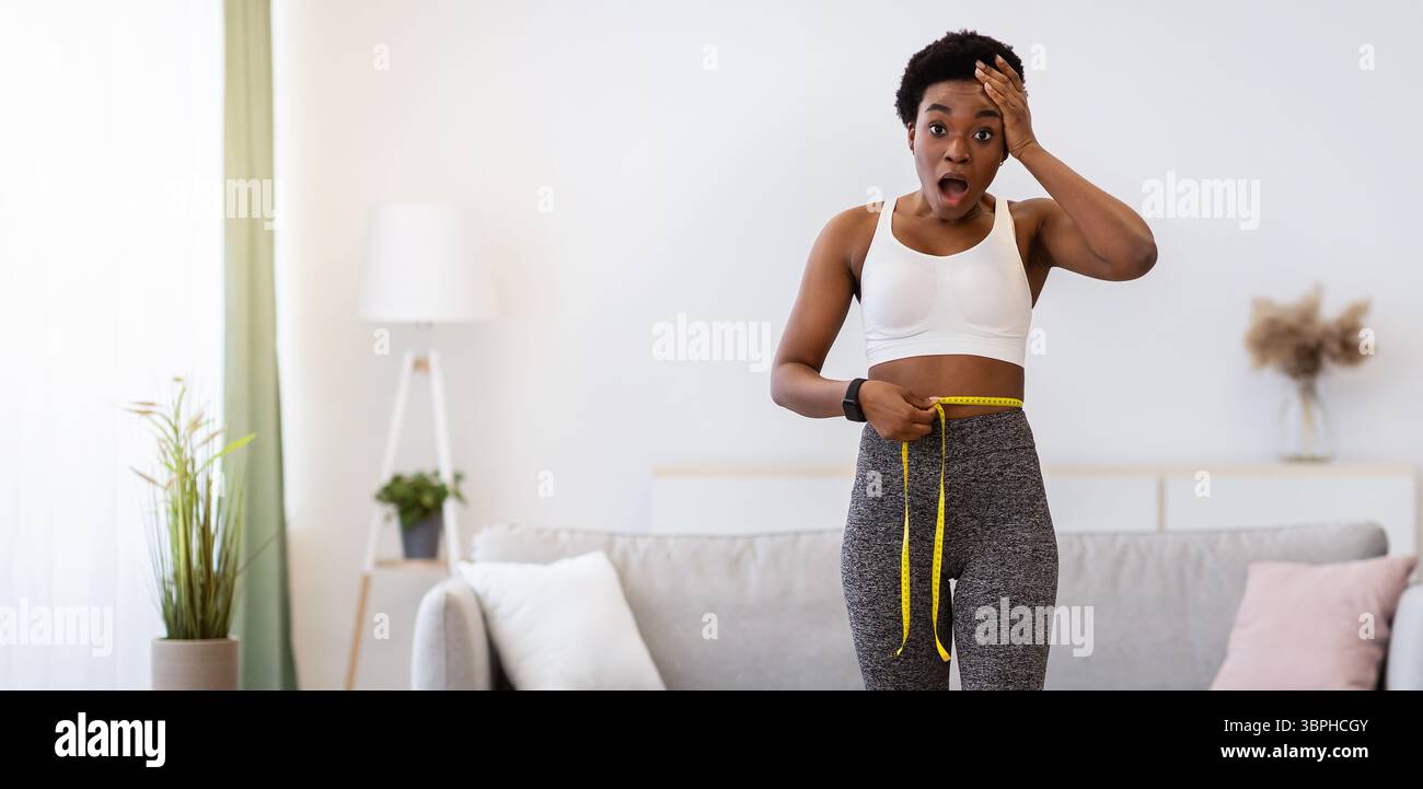 African Lady Weighing After Weight Gain And Measuring Waist Indoors ...