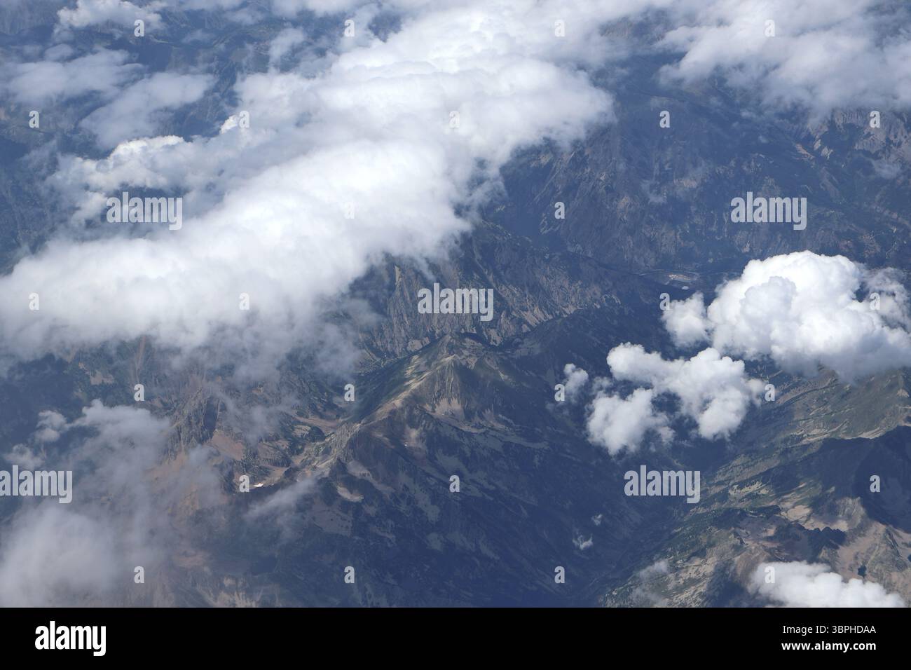 Aerial View of Alps, Mountain Peaks Partially Covered By Puffy Clouds ...