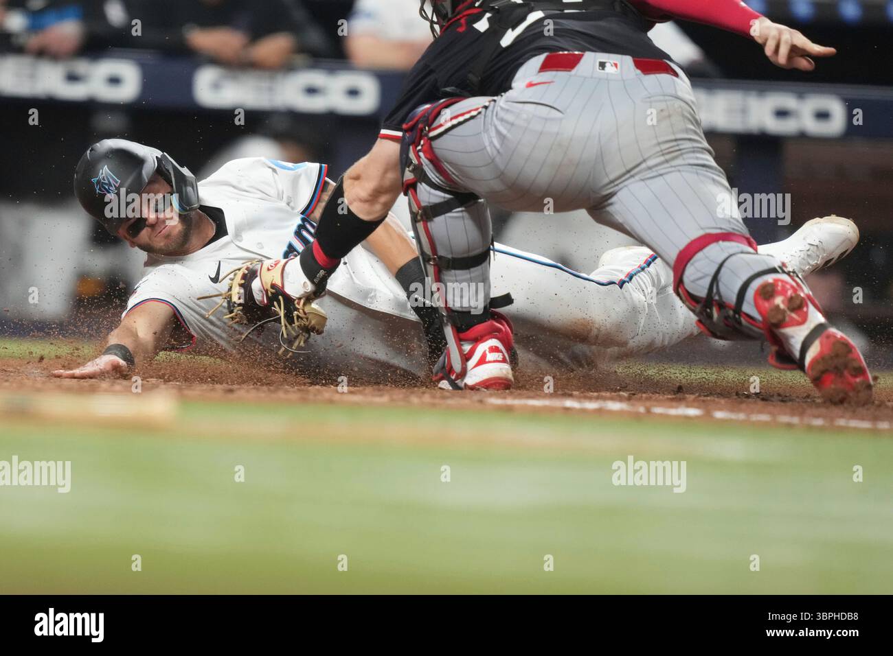 Miami Marlins' Connor Norby, left, is tagged out at the plate by ...