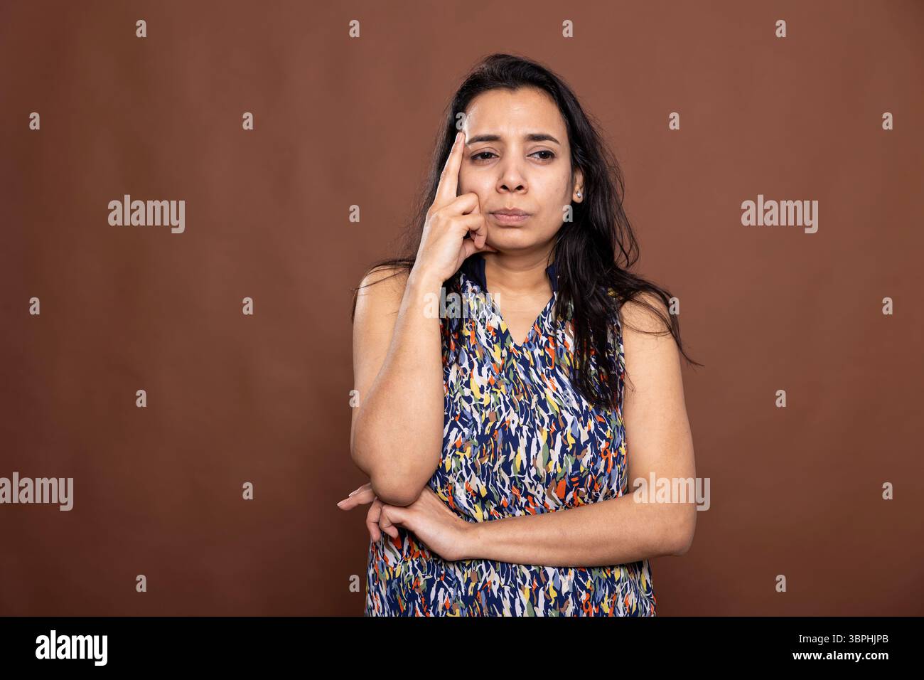 Serious young woman pressing temples hi-res stock photography and ...