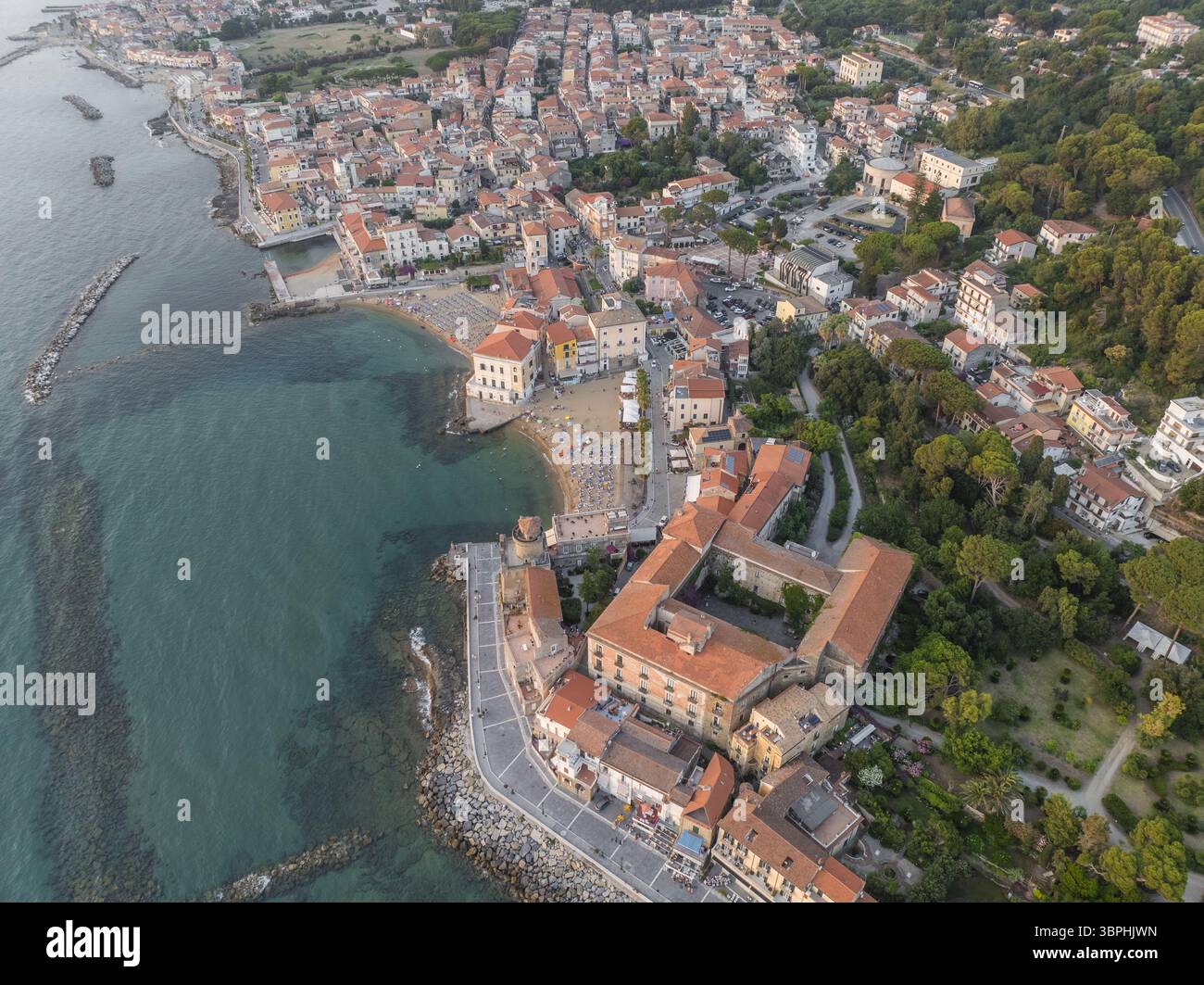Aerial view of turquoise waters meet the sandy beach and terracotta ...