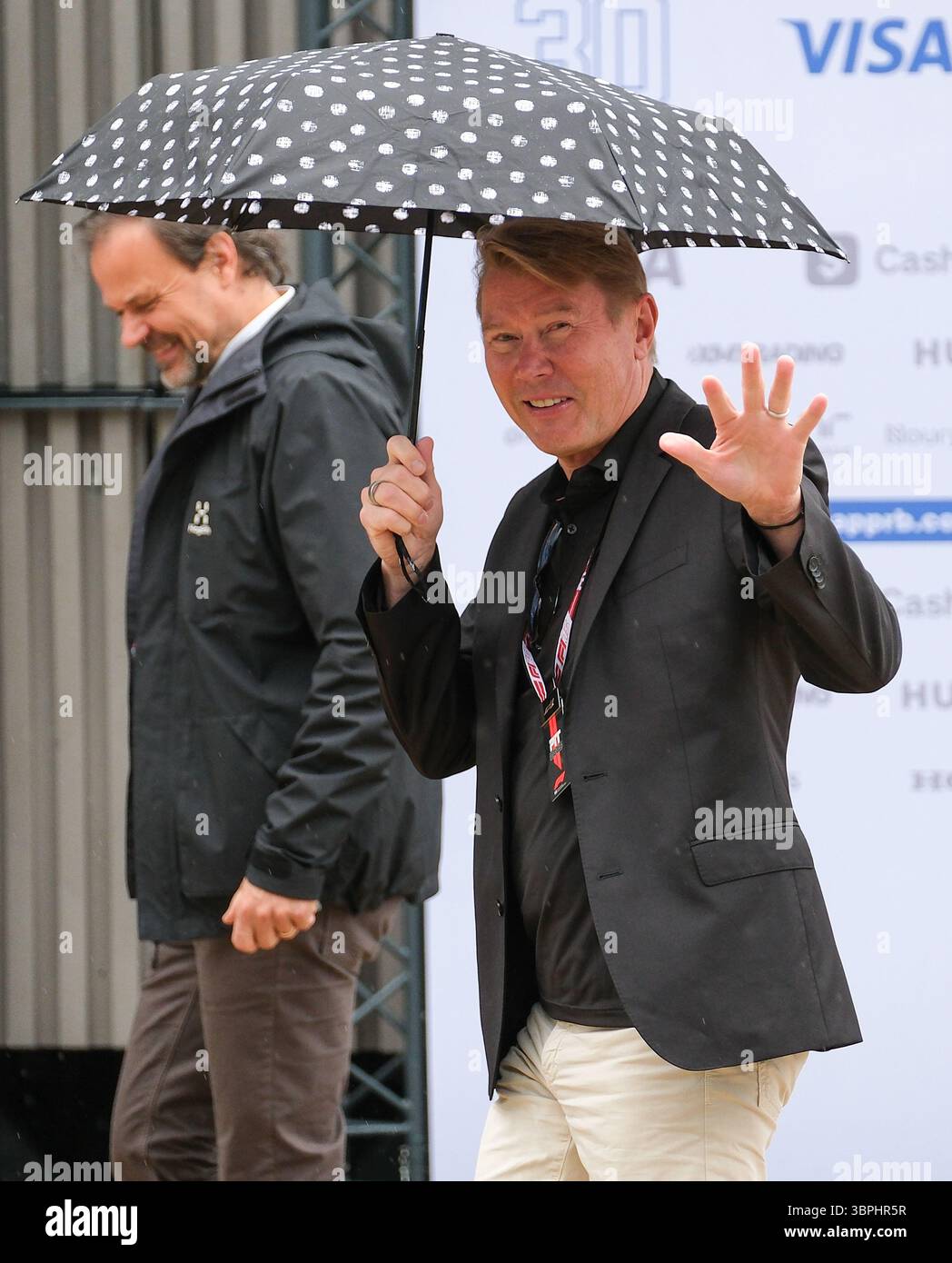Former F1 driver Mika Hakkinen arrives in the rain during the Formula ...