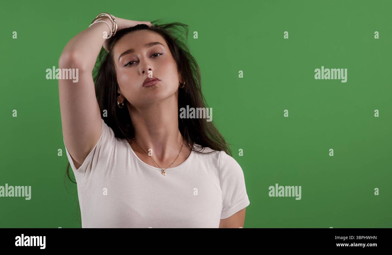 Fashion model posing on chroma key background, touching her hair Stock ...