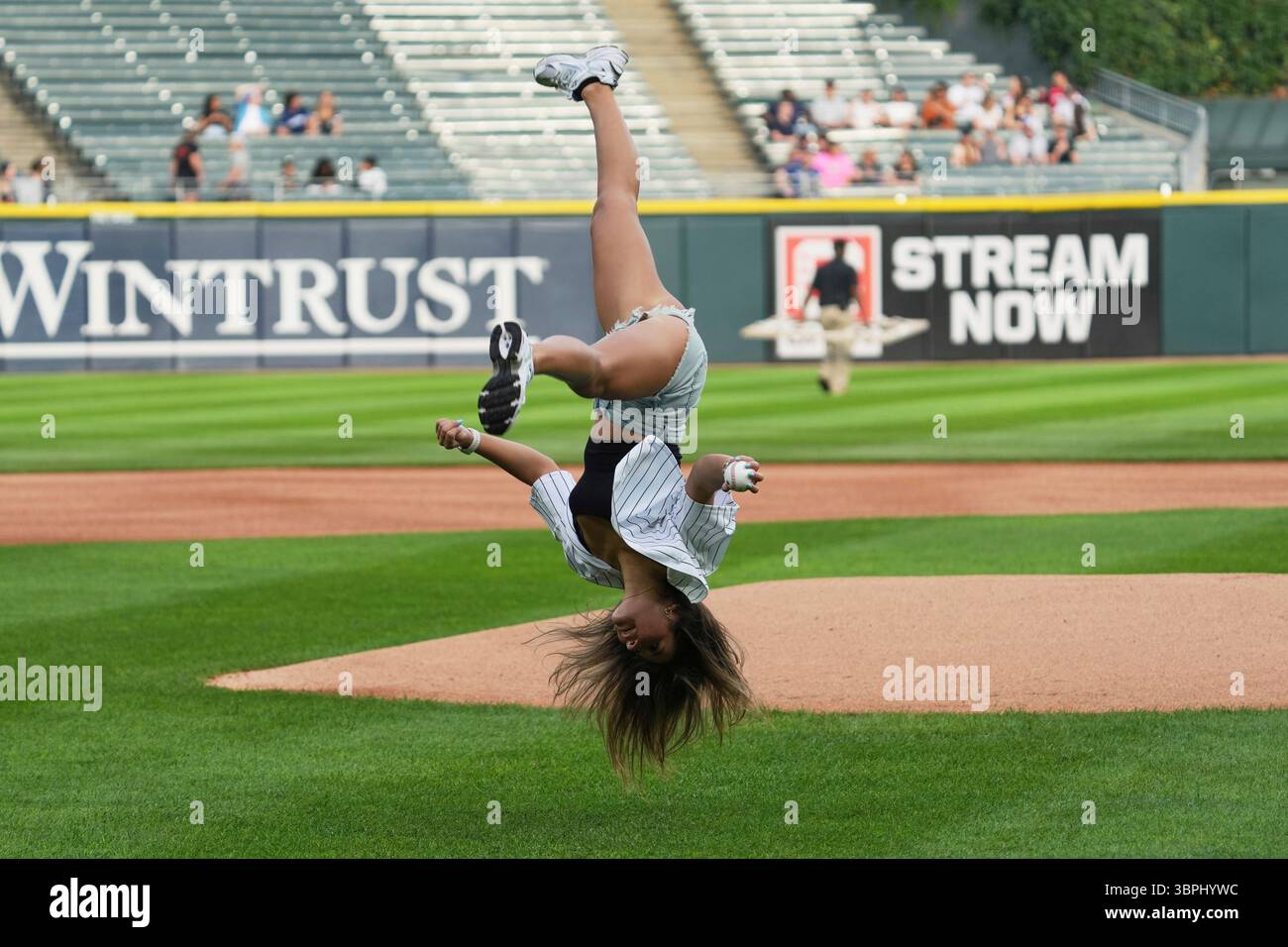 Chicago White Sox athlete Hannah Milton flips before throwing out the ...