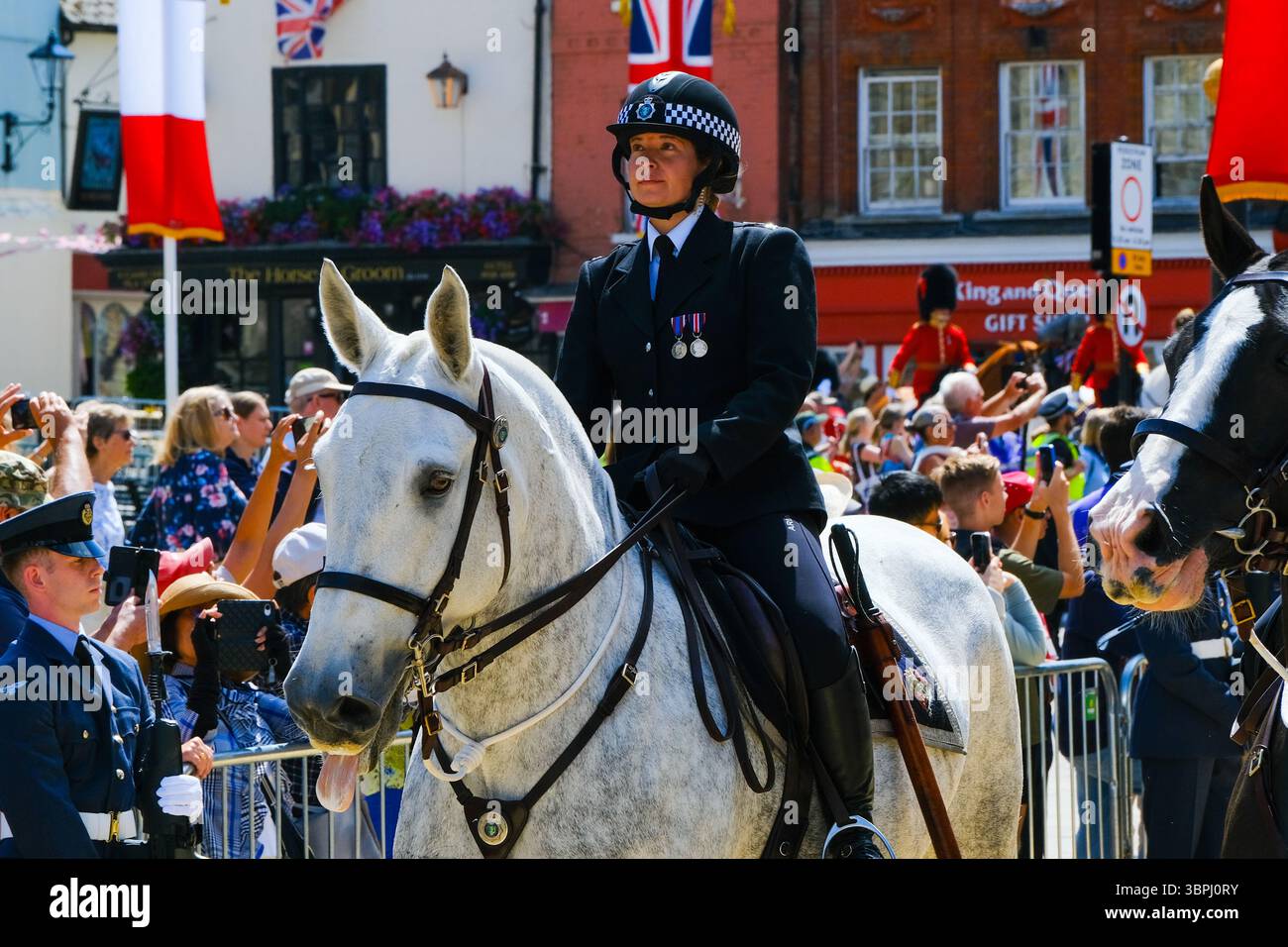 A mounted police officer rides ahead of the carriage procession in ...