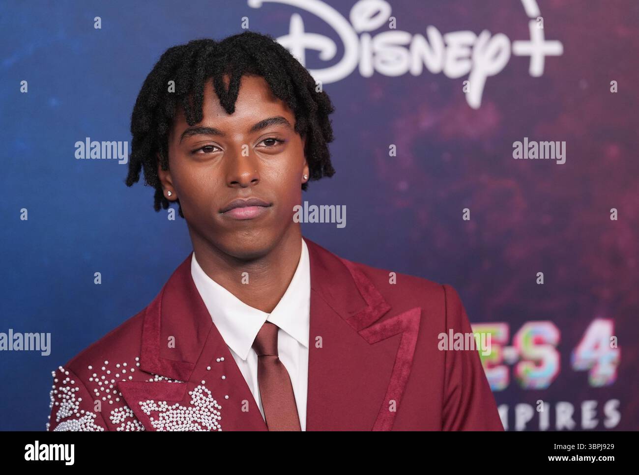 Mekonnen Knife poses at the premiere of "Zombies 4: Dawn of the ...