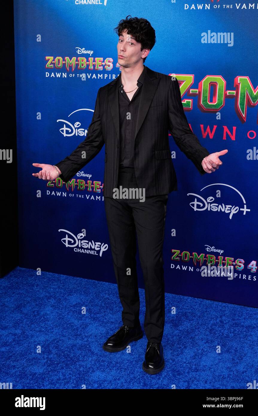Milo Manheim poses at the premiere of "Zombies 4: Dawn of the Vampires ...