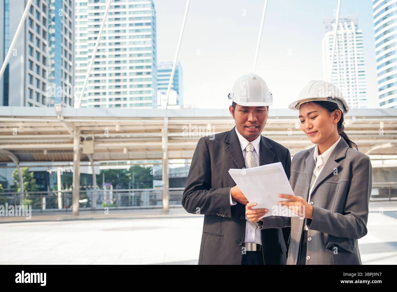 Civil engineer teams meeting working together wear worker helmets hardhat on construction site ...