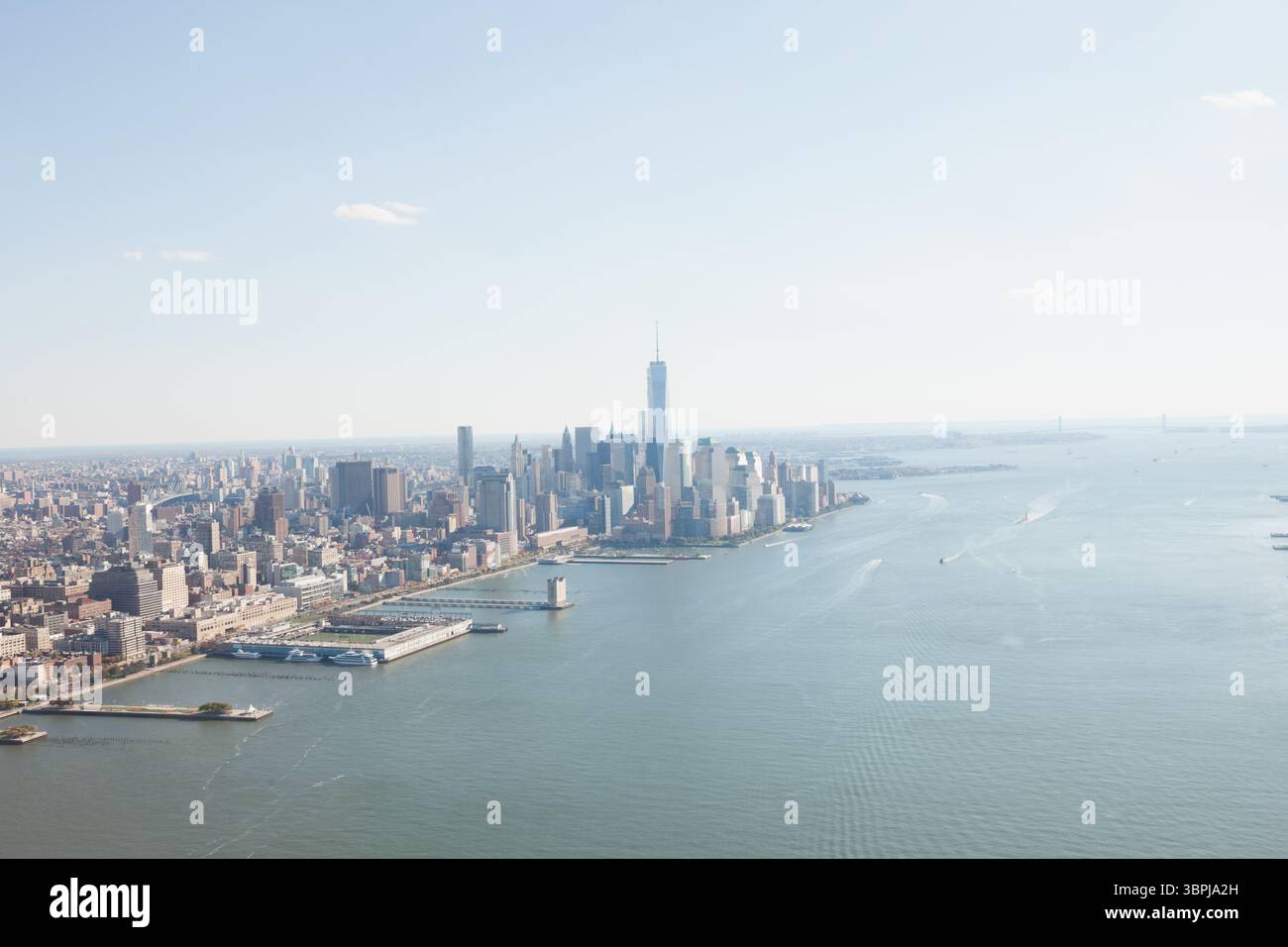 Cluster of skyscrapers is rising from waterfront peninsula in flat ...