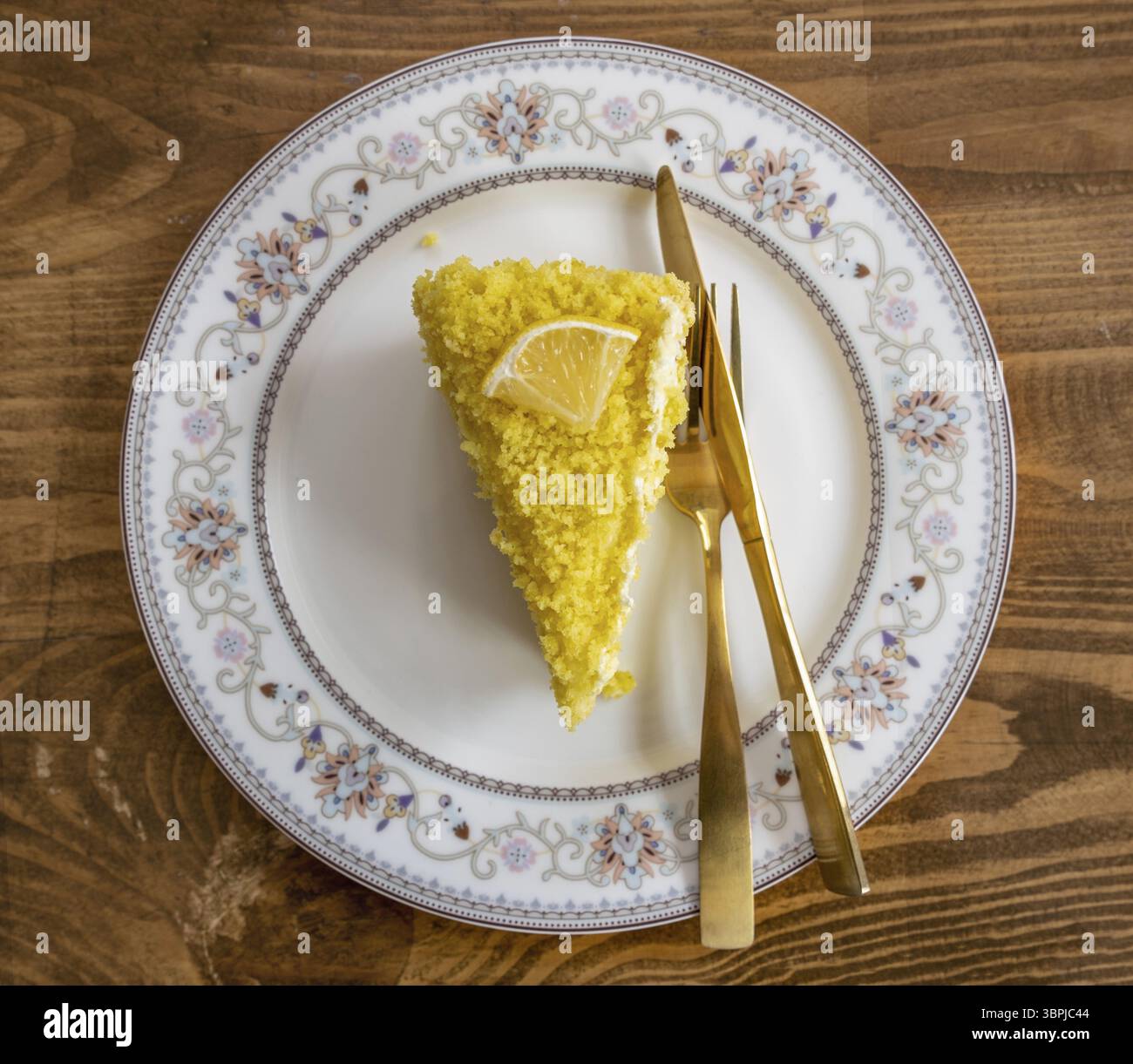 Triangle piece of lemon sponge cake on a plate, top view Stock Photo ...