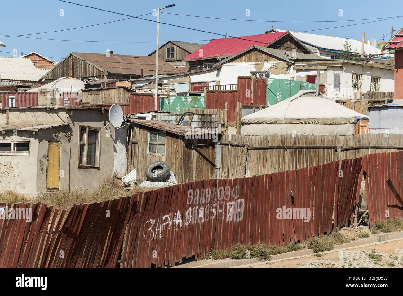 Plots of land with houses and yurts in the poor neighbourhood on the ...