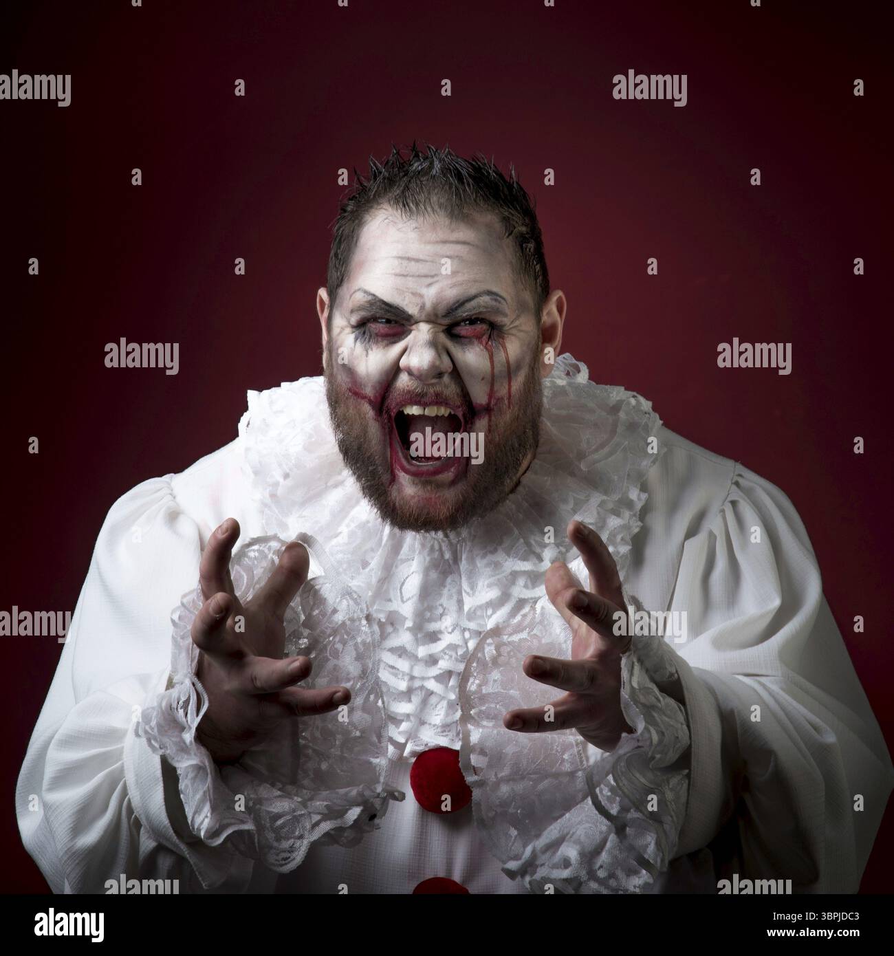 Portrait of a Scary Evil Clown. Studio shot with horrible face art ...