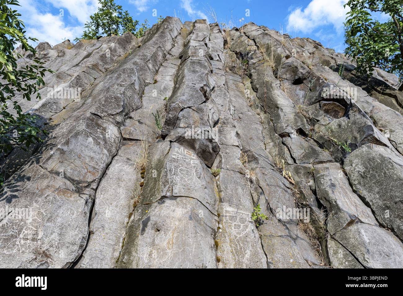 Vertically rising basalt columns in extreme lower view with scribbles ...