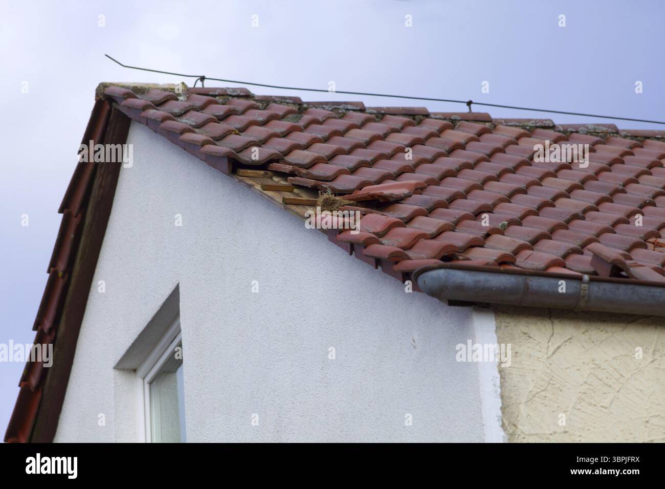 Home roof damage after storm. fallen shingles on house Stock Photo - Alamy