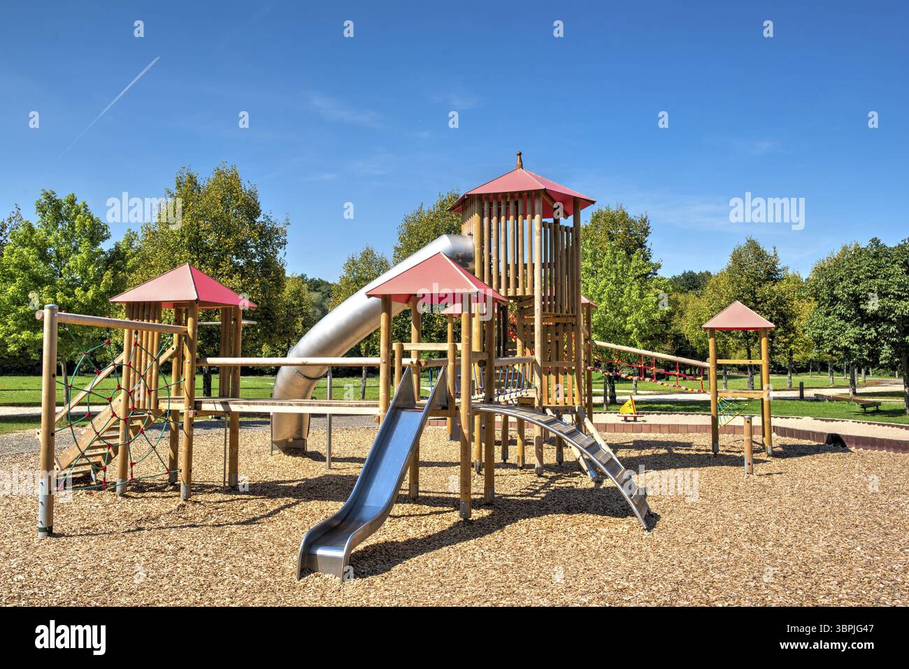 A wooden climbing castle with towers, palisades, slides, ropes and balancing poles on a deserted ...