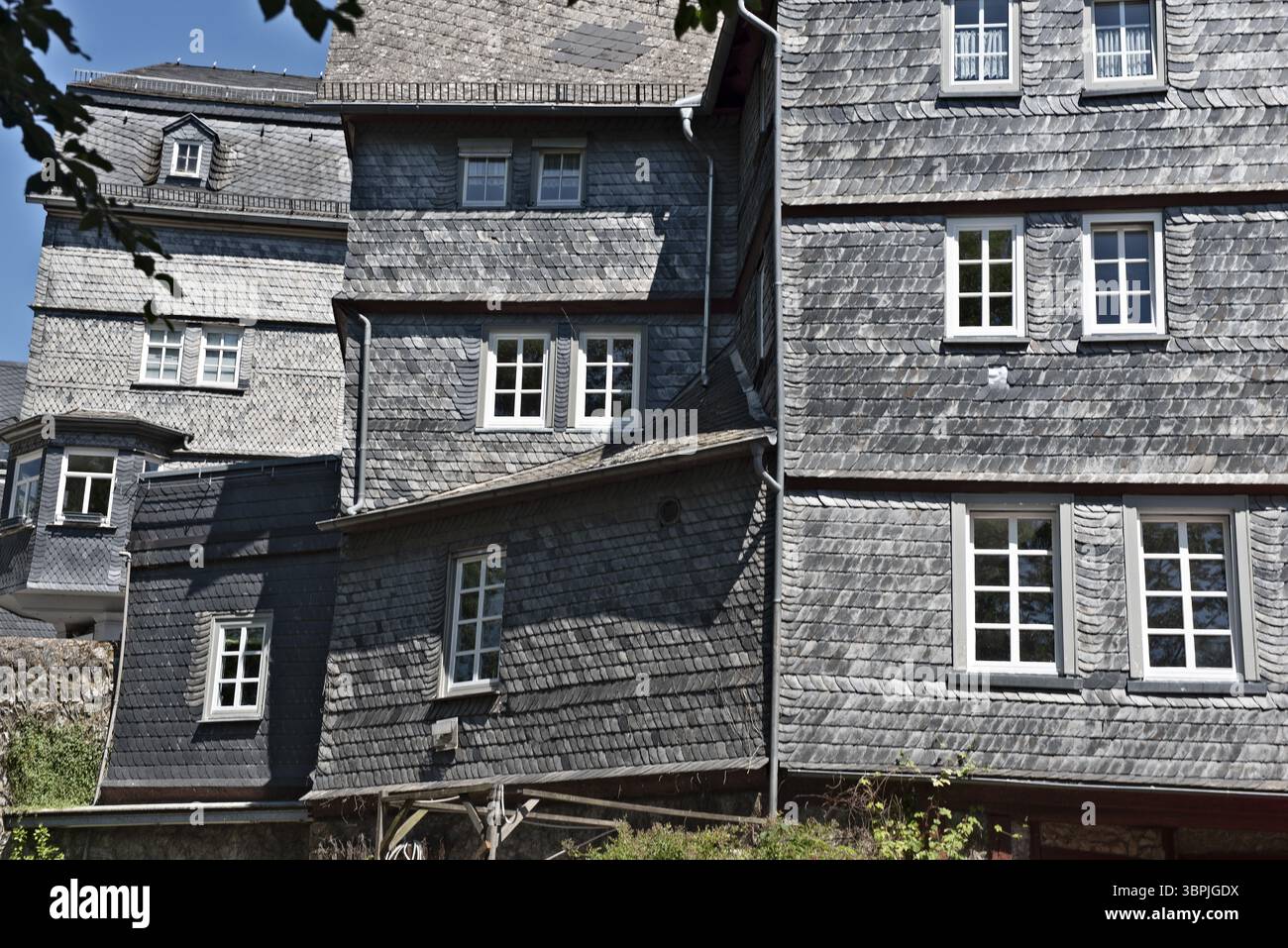 The slate-shingled wall of an old, angled residential building, Wetzlar ...