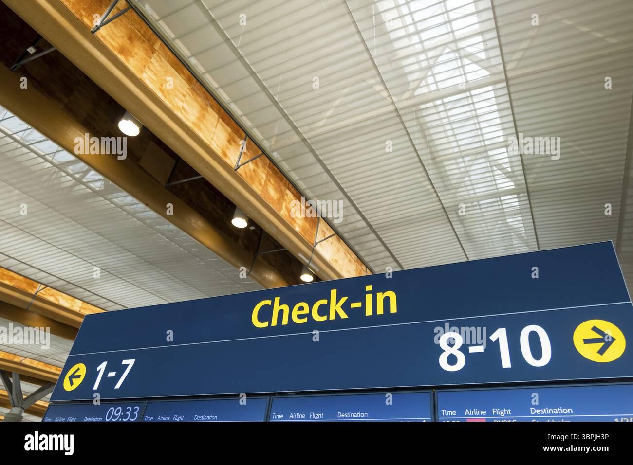 Airport flight boarding information screen and check-in counter sign in ...