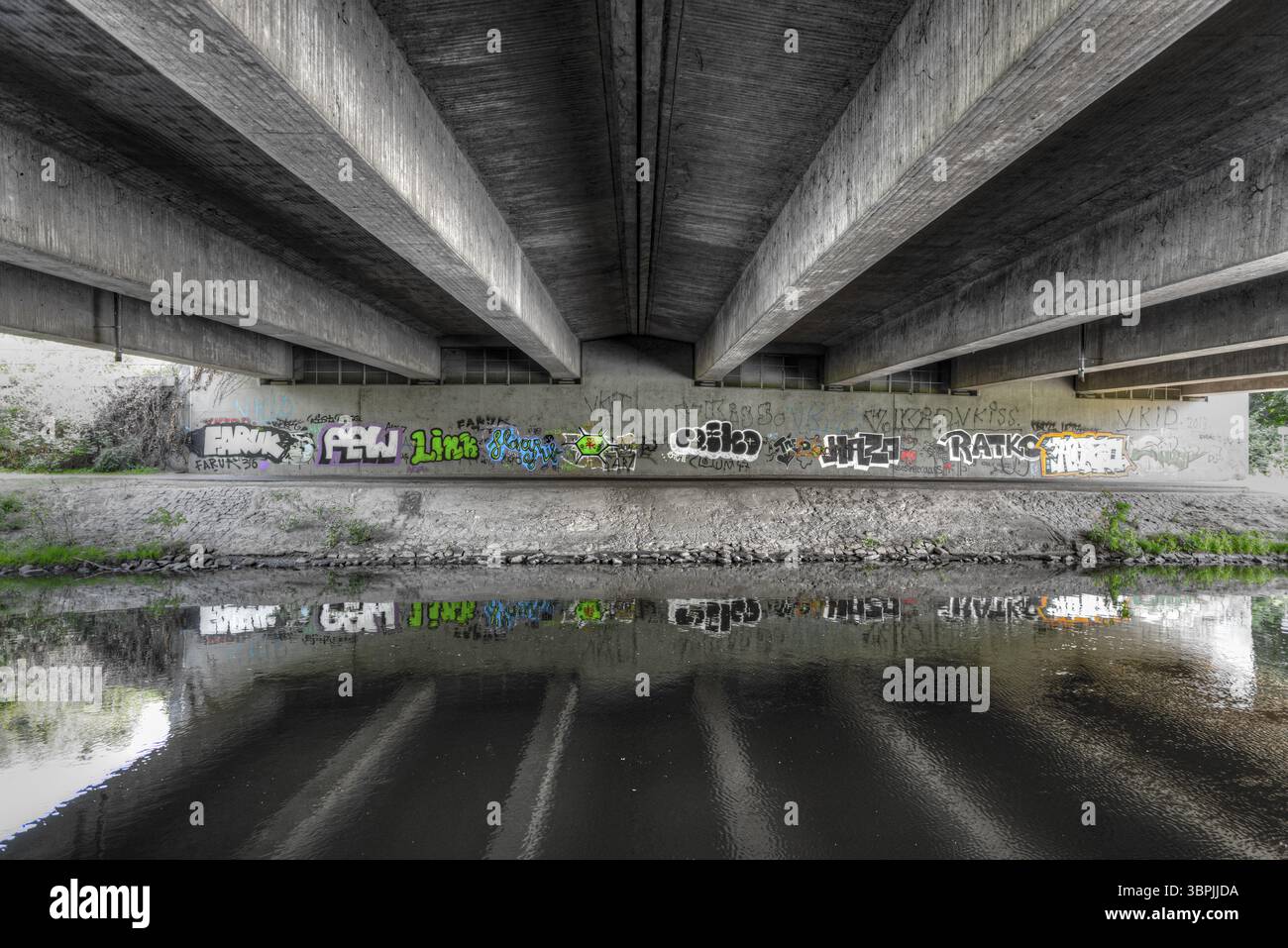 Underside of a dilapidated reinforced concrete motorway bridge with ...