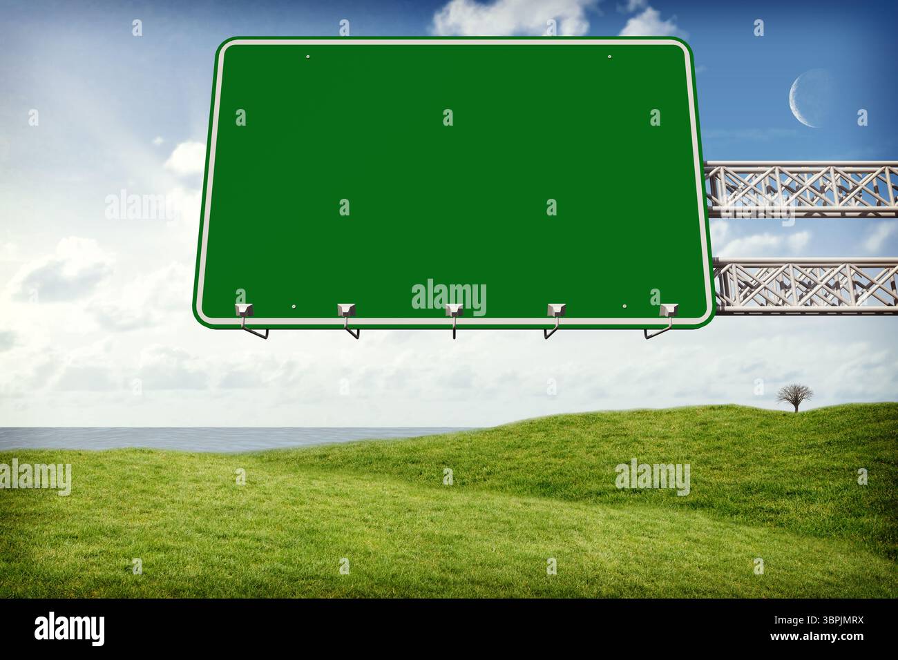 Showing blank green highway sign hanging on truss over grassy hill ...