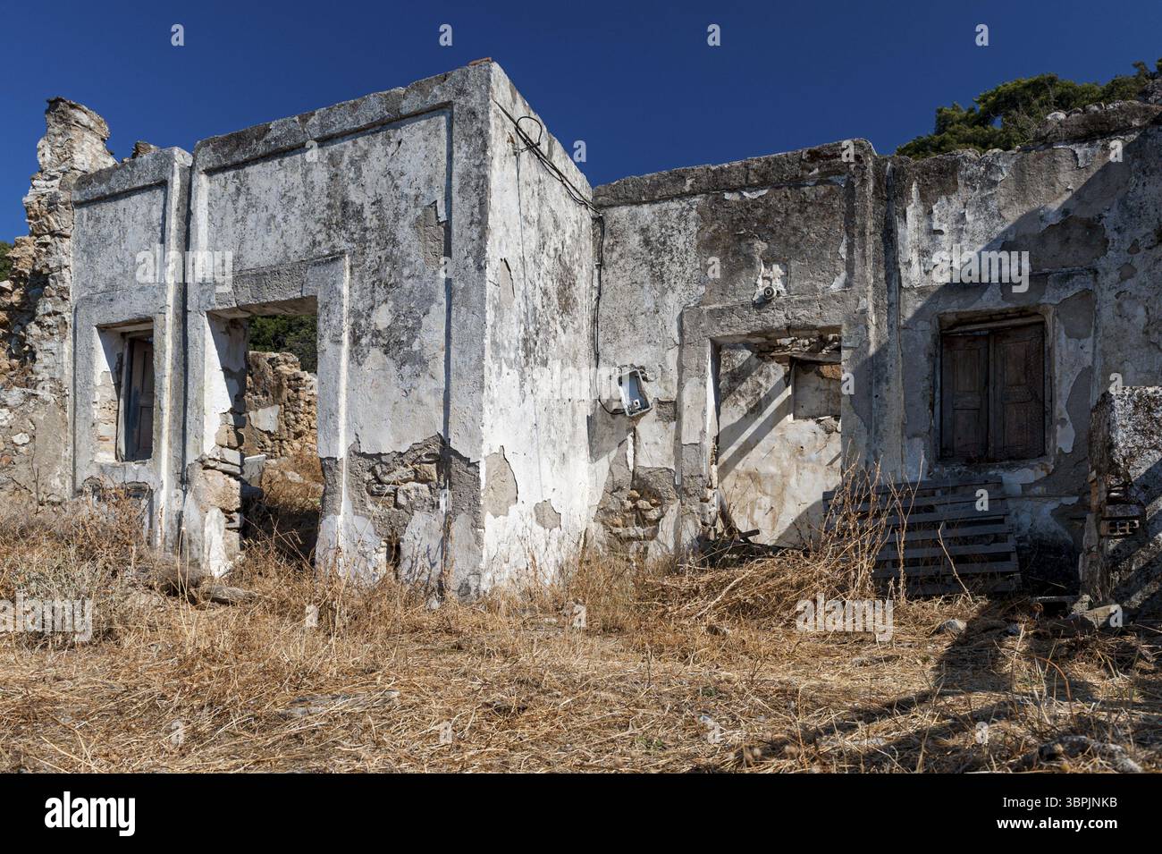 An old, dilapidated and abandoned house with a collapsed roof and ...