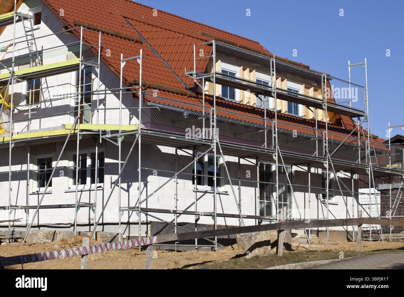 House under construction with scaffold Stock Photo - Alamy