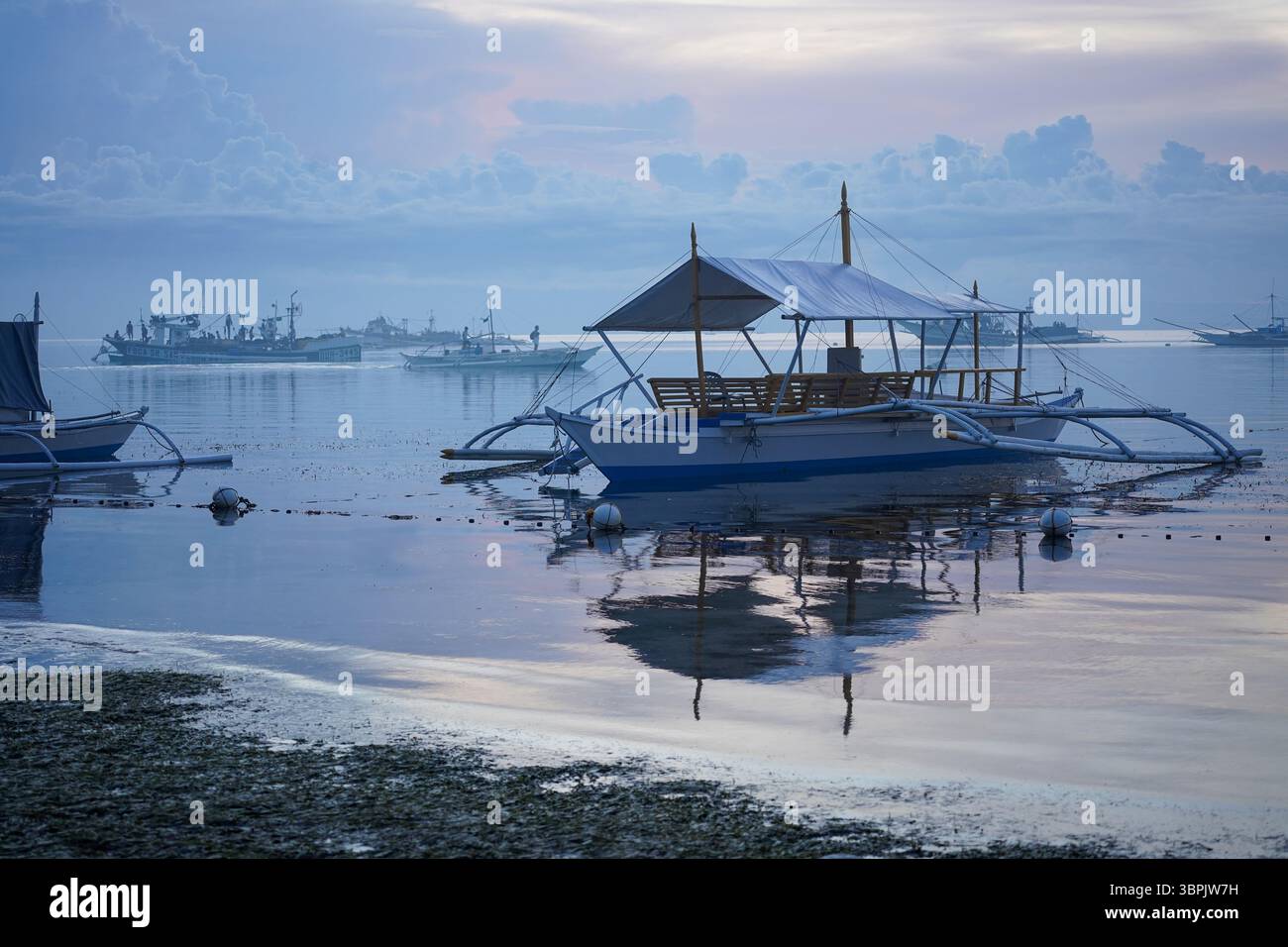 Bangka fishing boat in the Philippines at sunset Stock Photo - Alamy