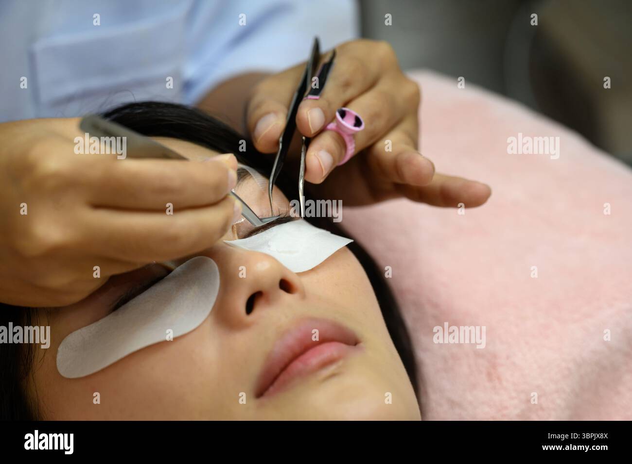 Beauty procedure showing expert lash placement and careful technique ...