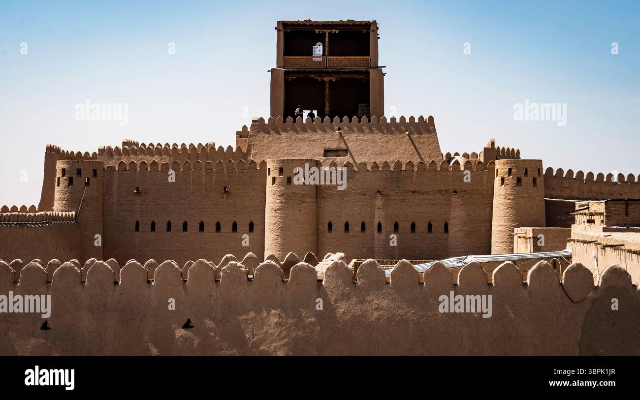 A historic fortress with tall walls and a watchtower, set against a ...