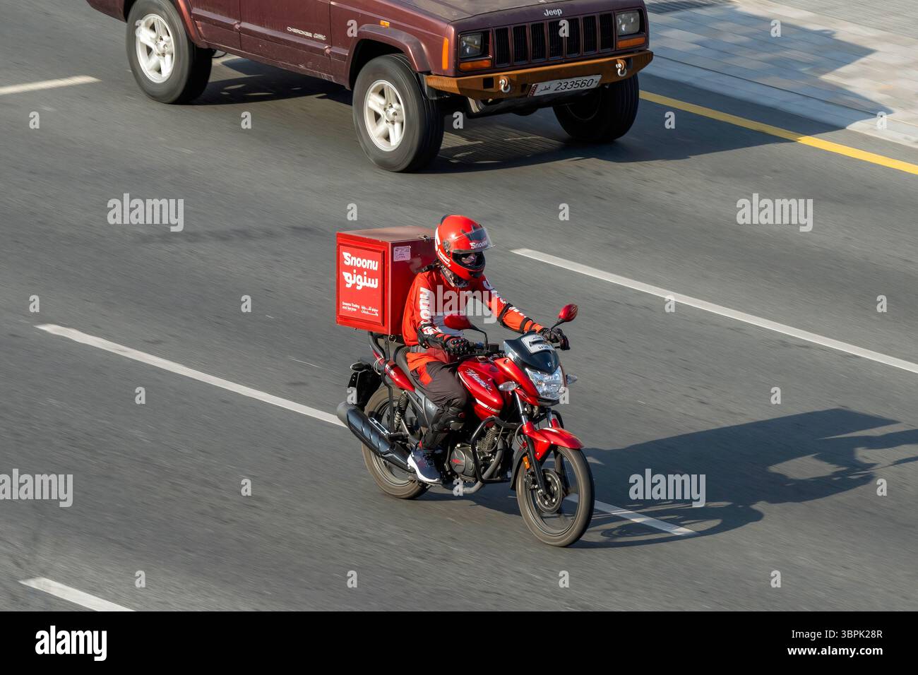 Snoonu Delivery boy food Delivery rider on road Doha Qatar Stock Photo ...