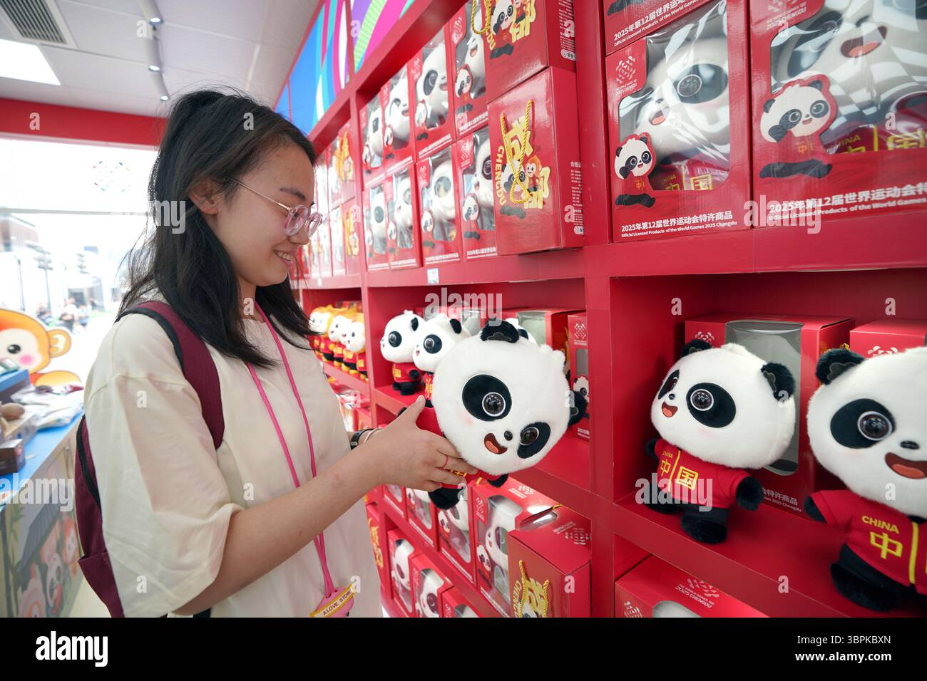 A woman purchases the mascot Shubao of the World Games 2025 Chengdu ...