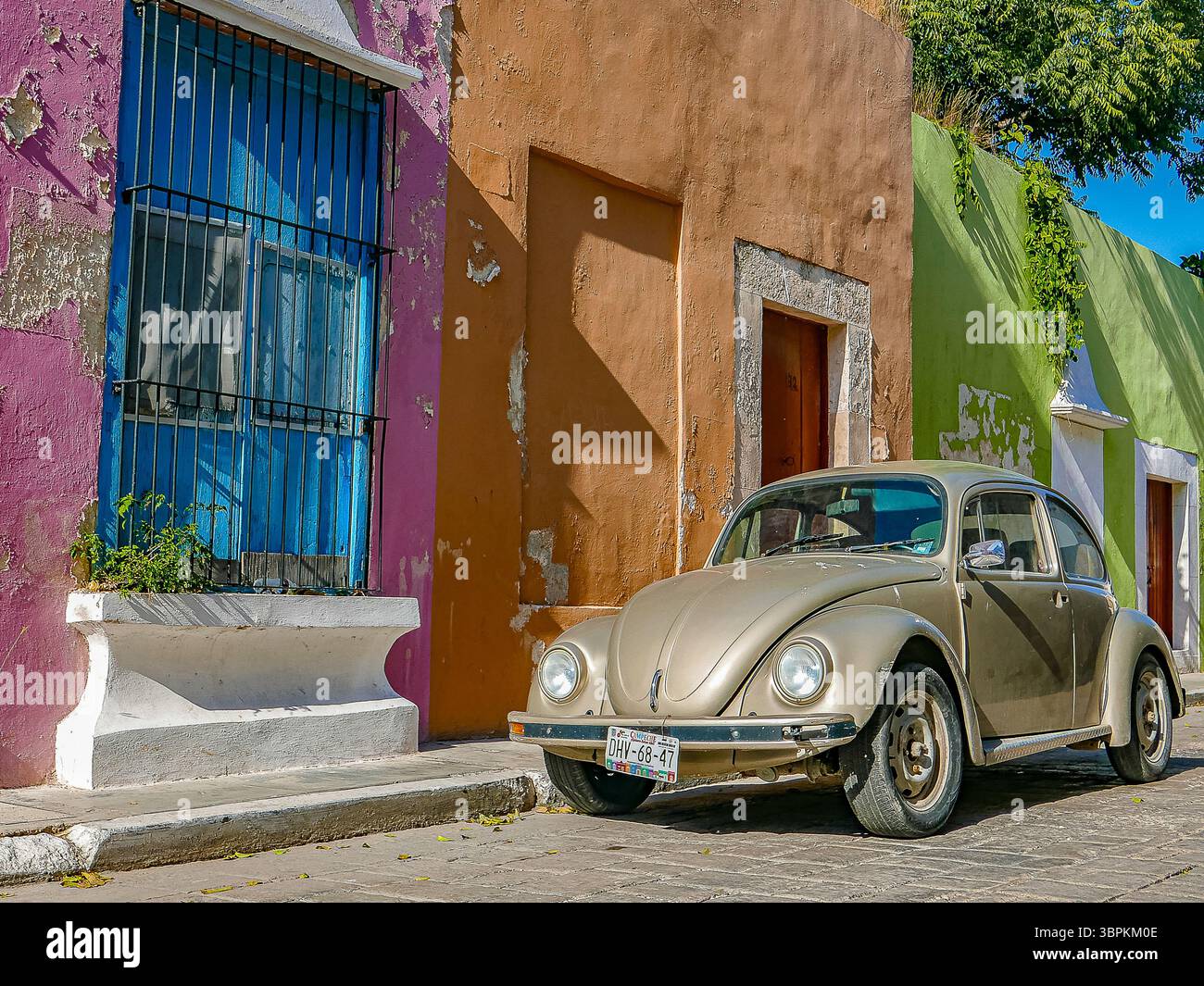 Vintage Volkswagen Beetle parked on a colorful colonial street with ...