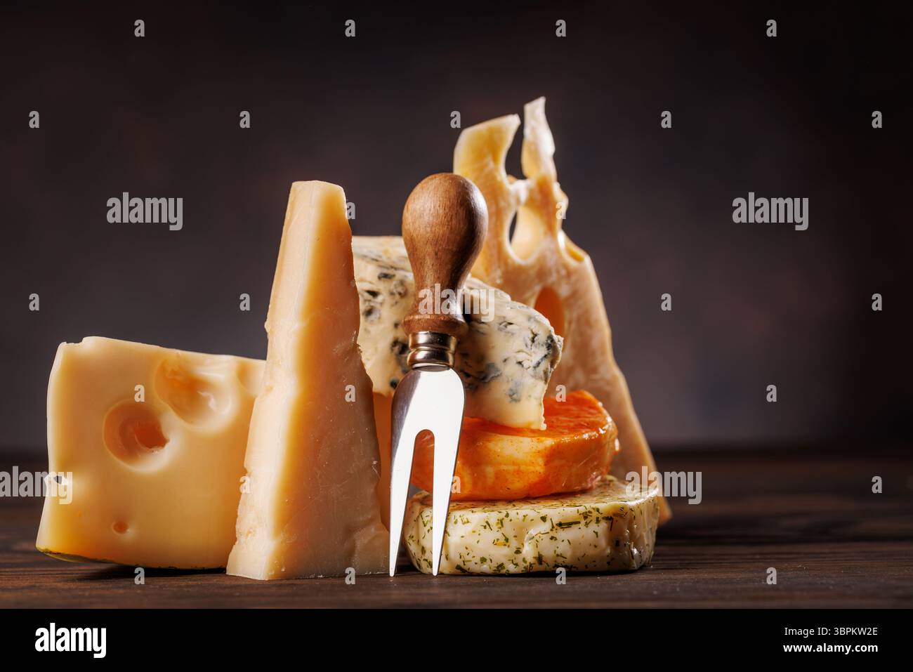 Assorted cheeses in different shapes and textures displayed together on ...