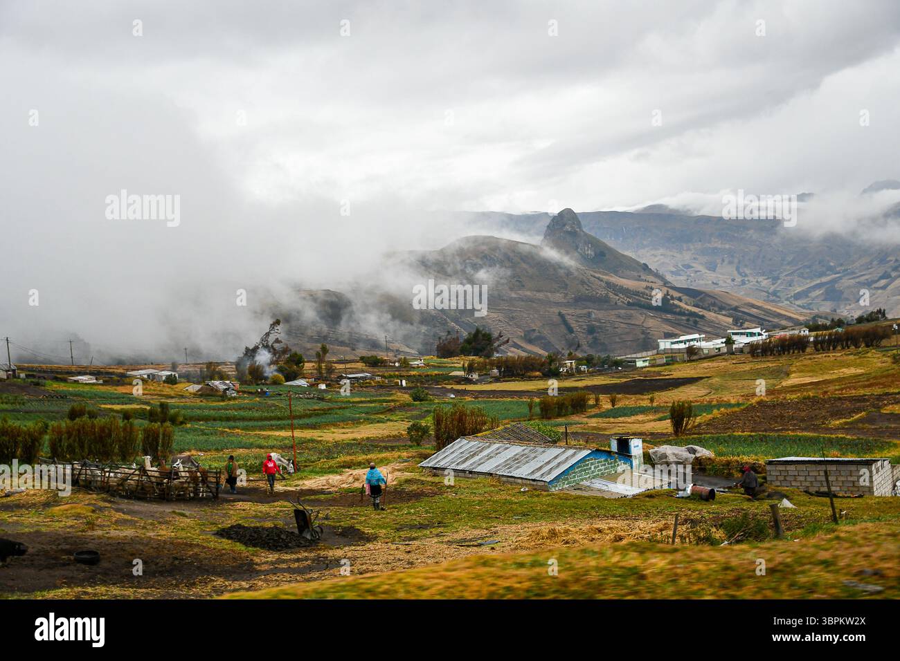 Small Andean farming village nestled among fields and mountains in ...