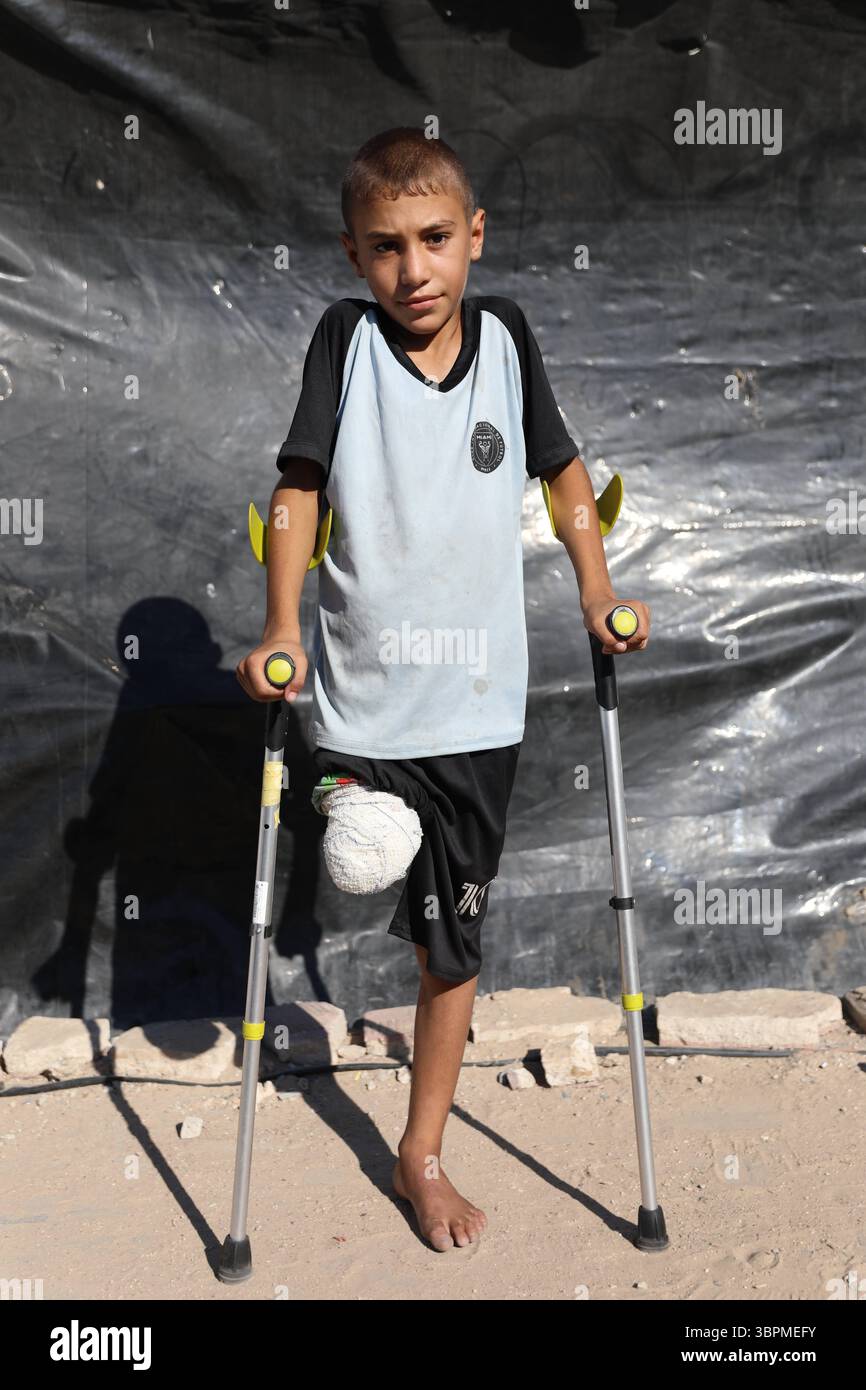 10-year-old Muhammed Omar Selim Muslih, who followed his father to get ...