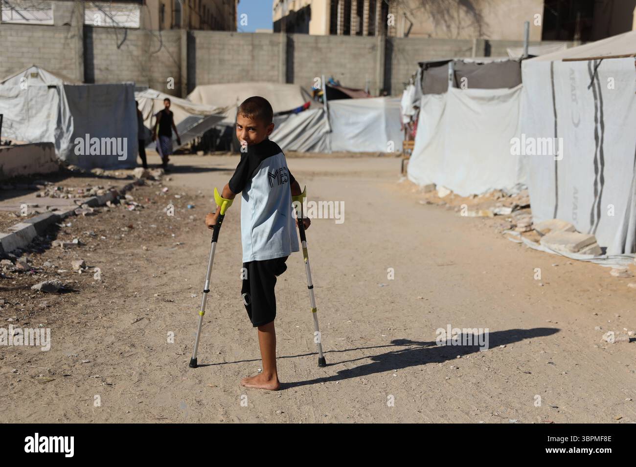 10-year-old Muhammed Omar Selim Muslih, who followed his father to get ...