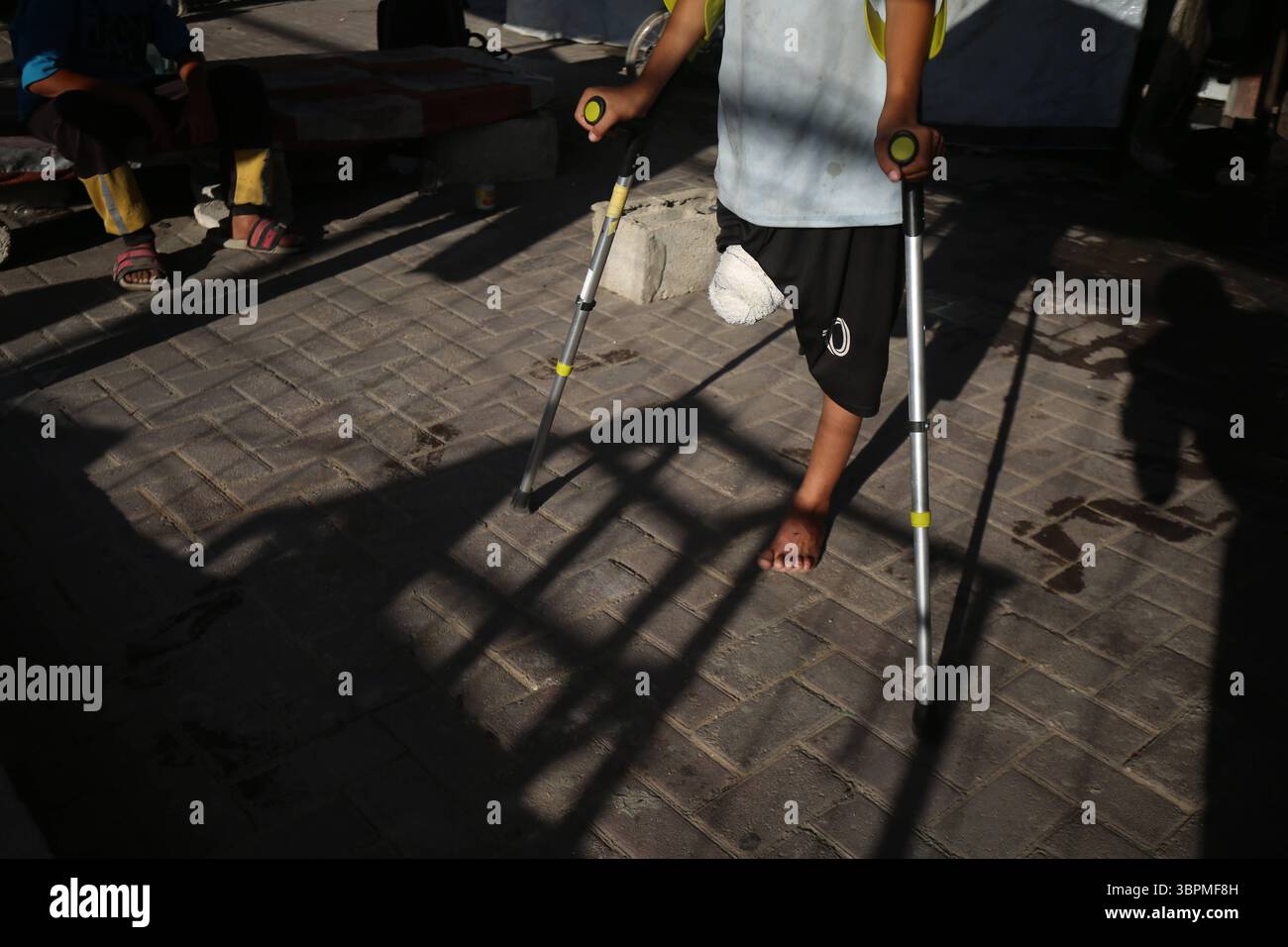 10-year-old Muhammed Omar Selim Muslih, who followed his father to get ...