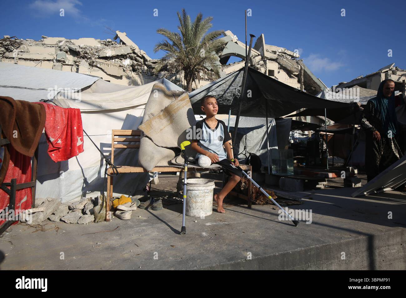 10-year-old Muhammed Omar Selim Muslih, who followed his father to get ...