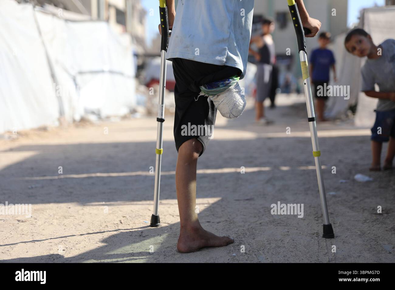 10-year-old Muhammed Omar Selim Muslih, who followed his father to get ...