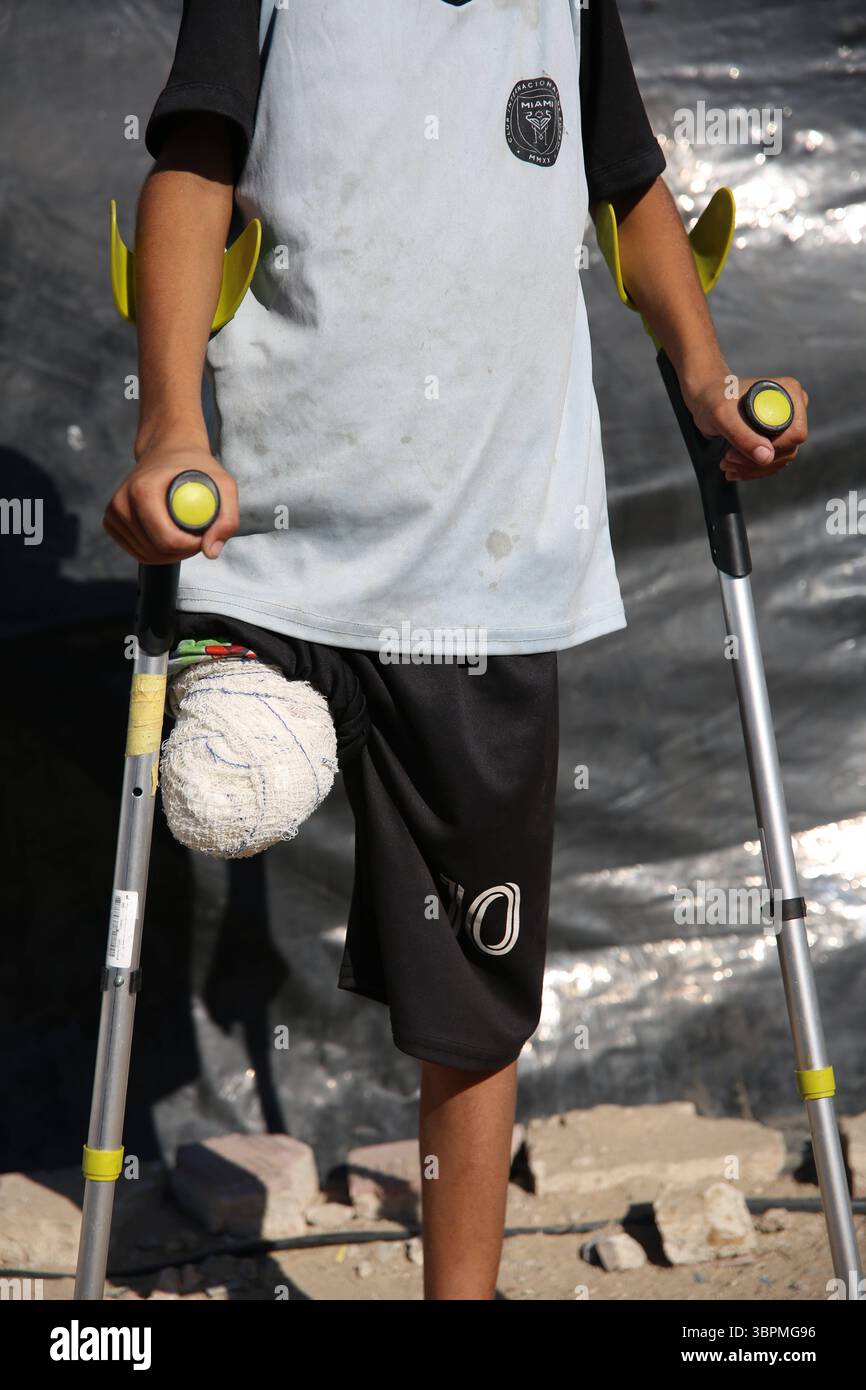 10-year-old Muhammed Omar Selim Muslih, who followed his father to get ...