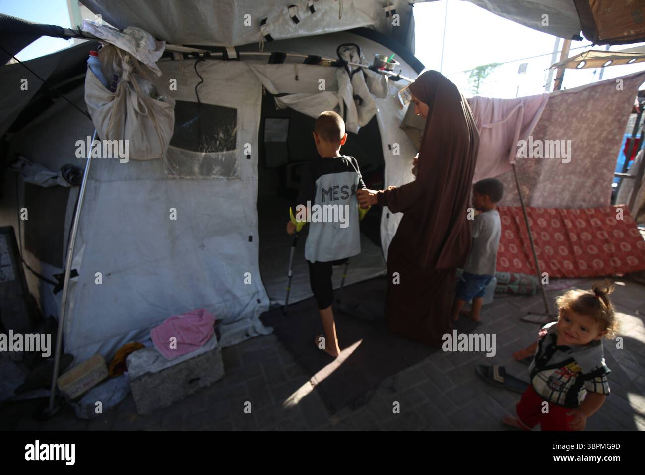 10-year-old Muhammed Omar Selim Muslih, who followed his father to get ...