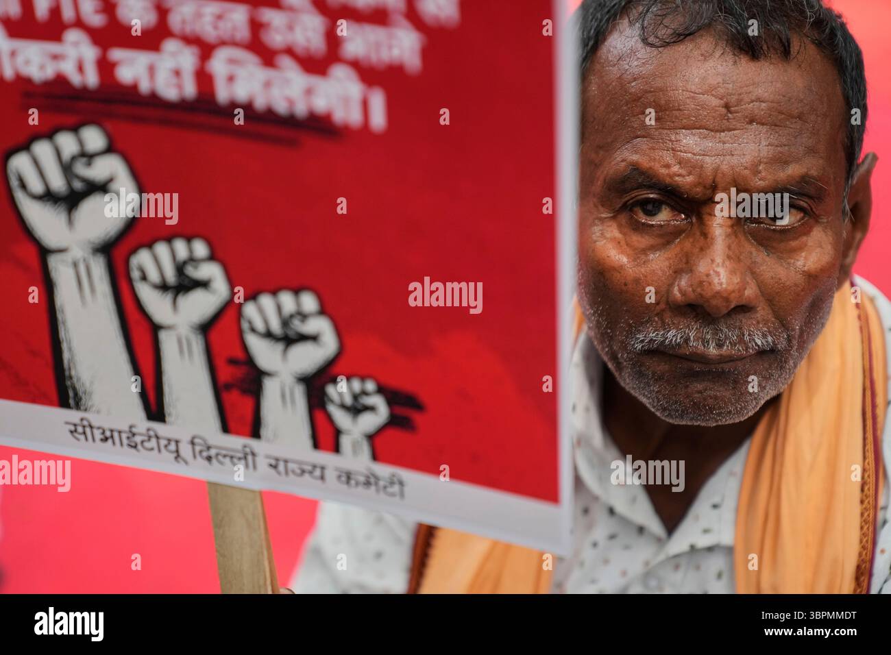 A laborer holds a banner as he participates in a nationwide strike ...