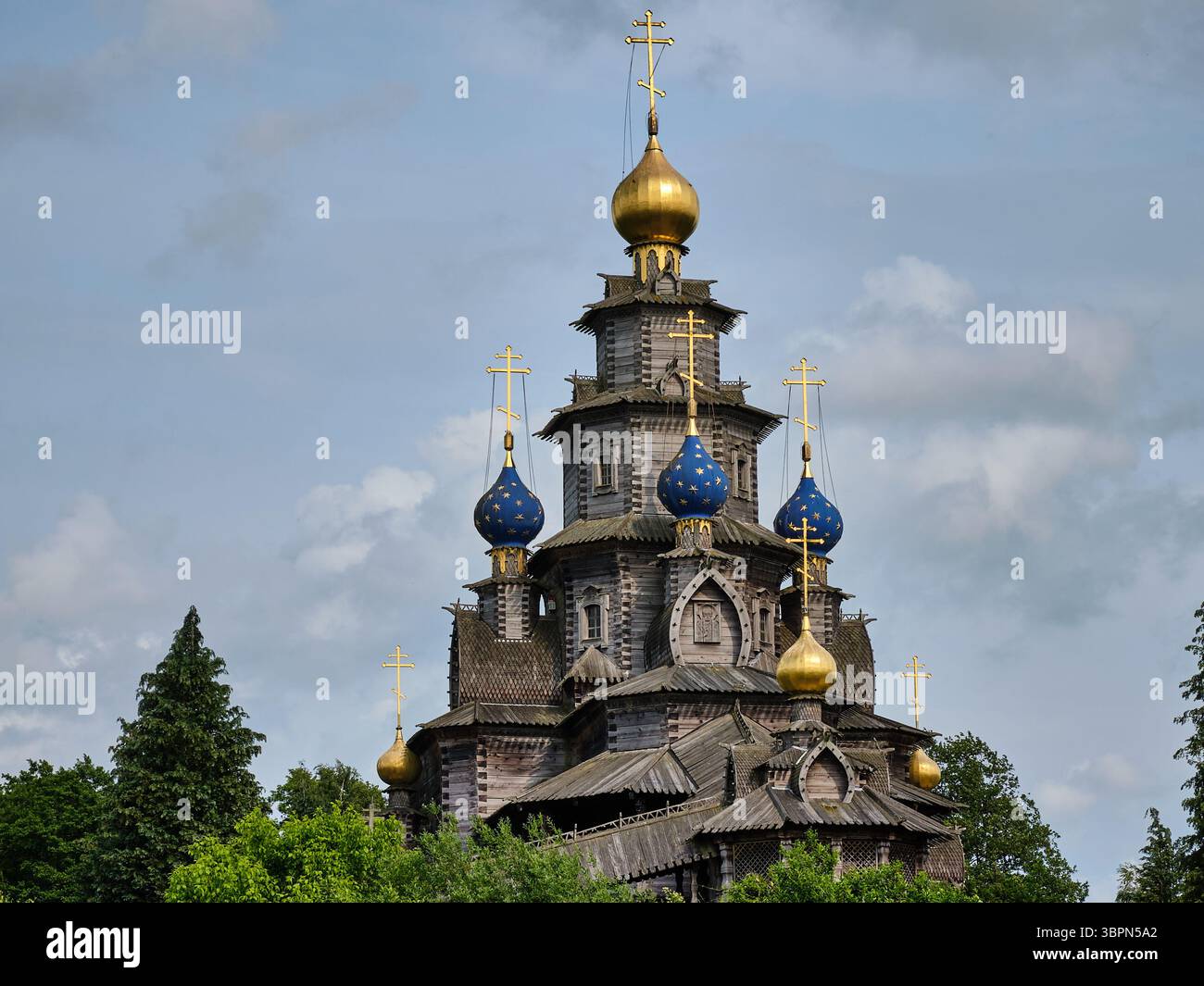 Replica of a historic Russian stave church dedicated to St. Nicholas, featuring eight gilded ...