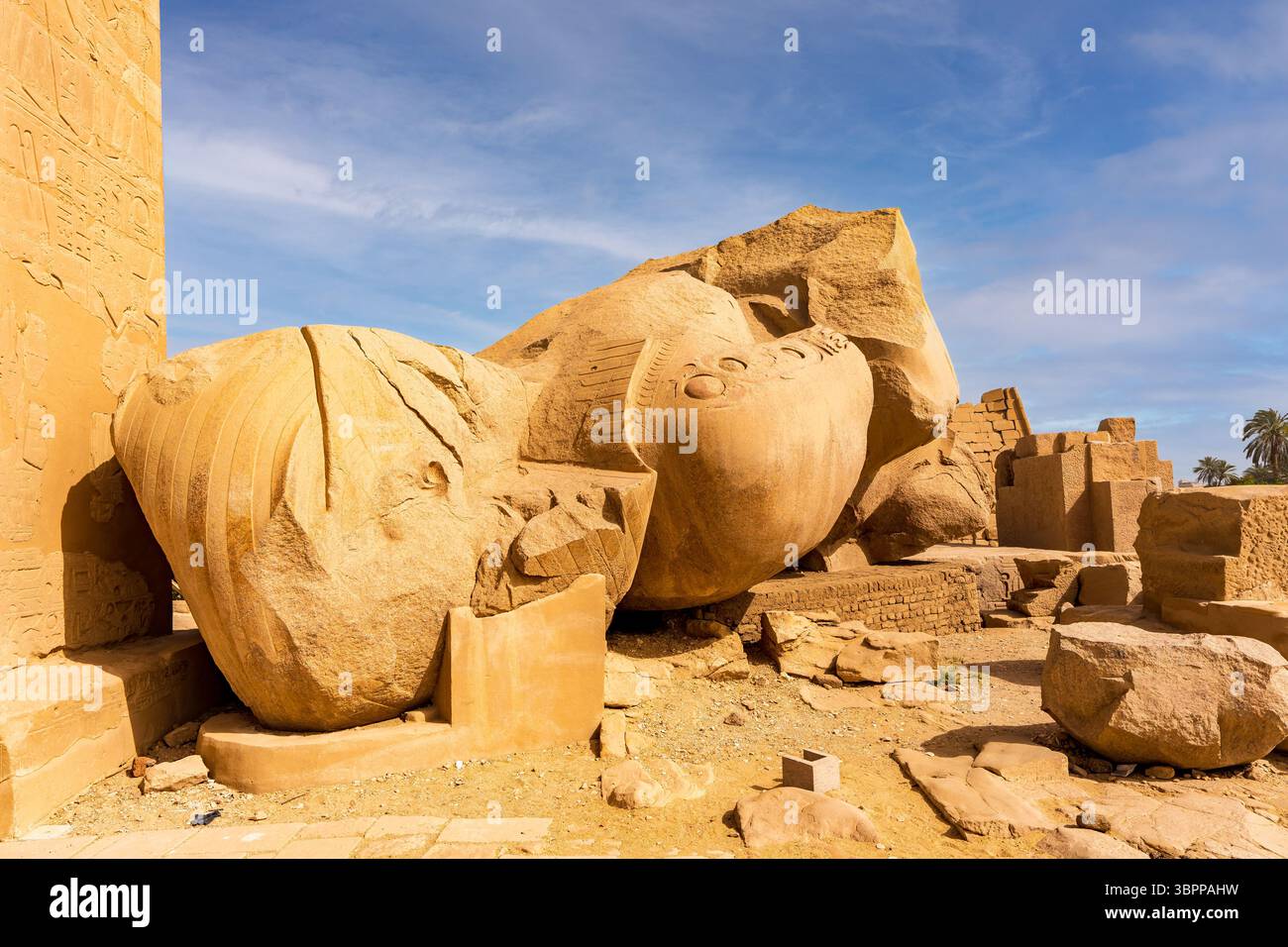Giant statue of Ramses II on the ground, Ramesseum, Luxor Stock Photo ...