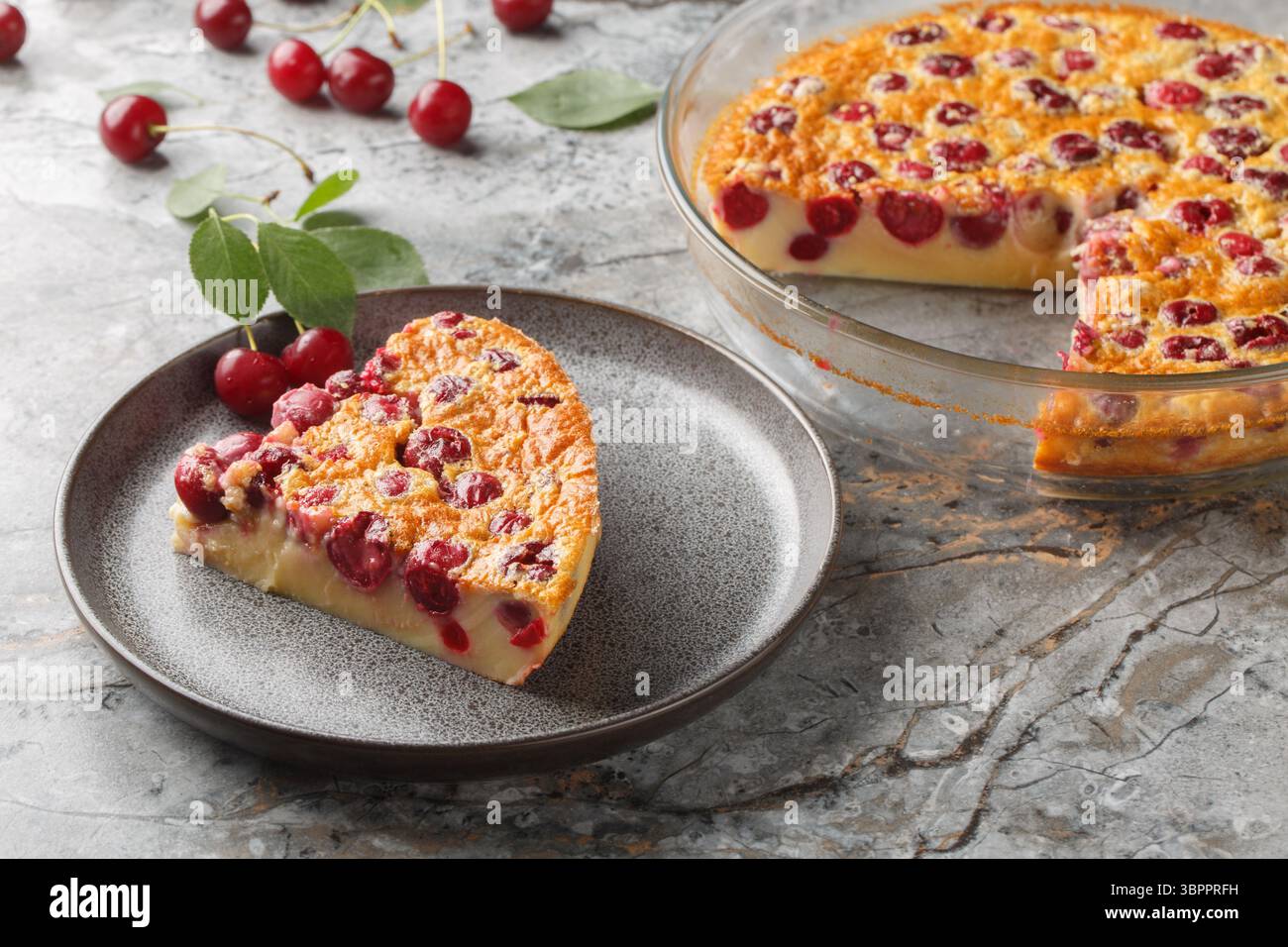 Delicious sweet piece of cherry pie clafoutis close-up in a plate on ...