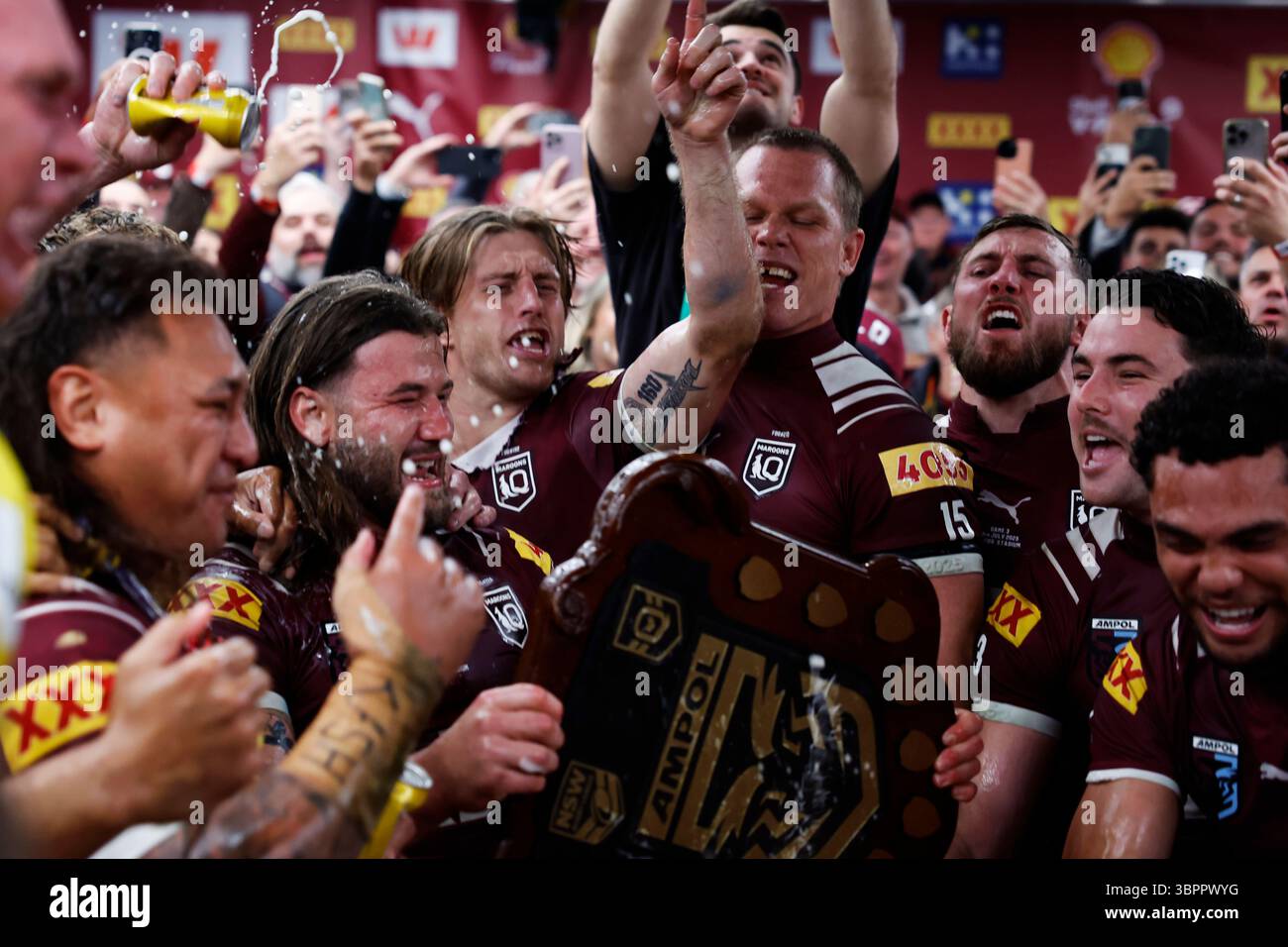 Maroons players sing the team song in the rooms after their victory ...