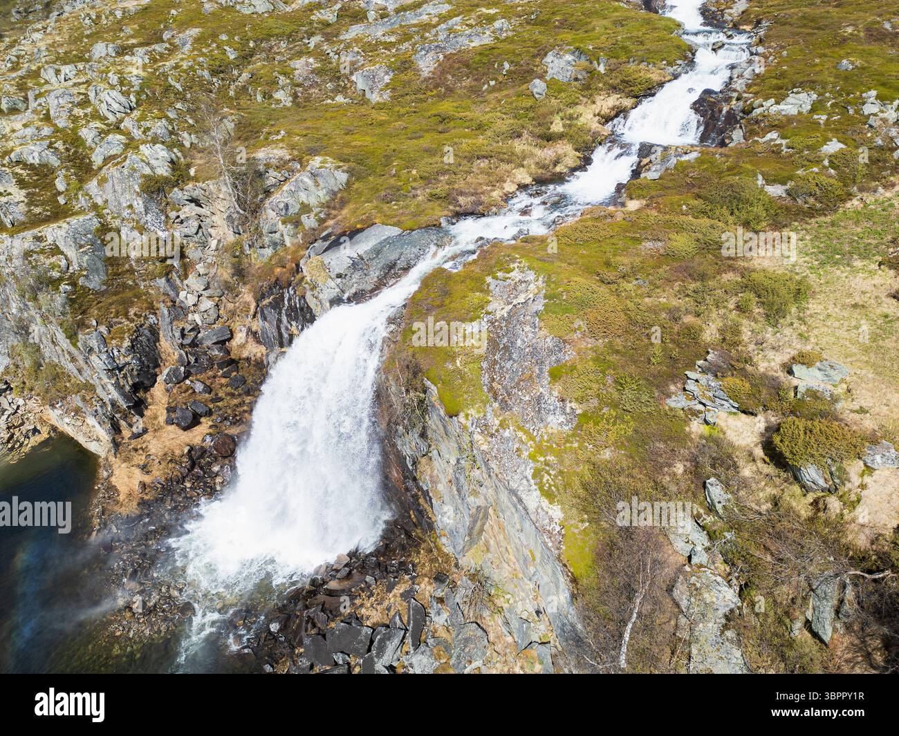 Aerial view of a picturesque waterfall falling from the rocks in the ...