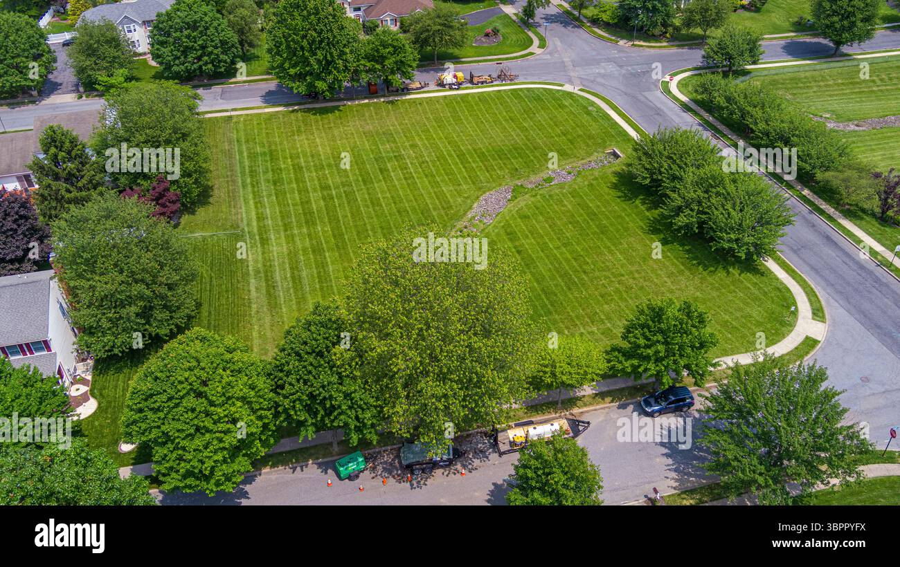 Aerial view of water retention basin swale in suburban neighborhood ...
