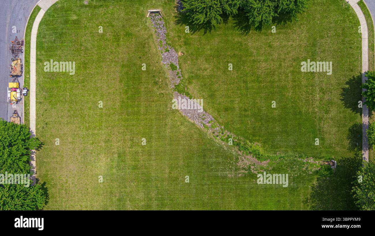Aerial view of water retention basin swale in suburban neighborhood ...