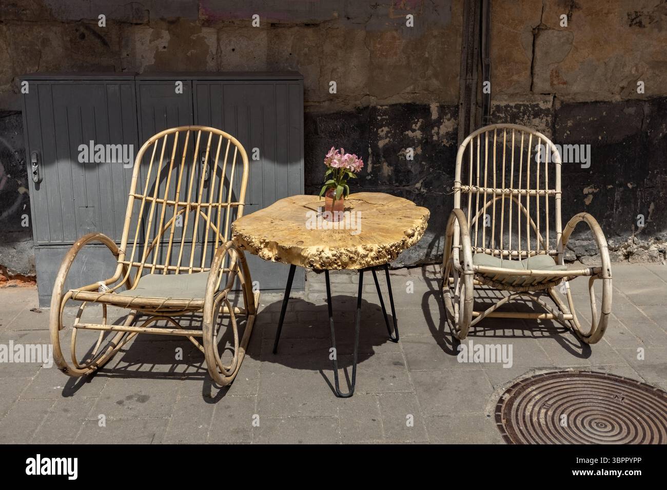 Tea table and two cozy wicker chairs Stock Photo - Alamy