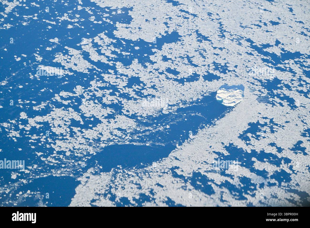 Aerial view of sea ice floes floating on the Arctic Ocean near ...